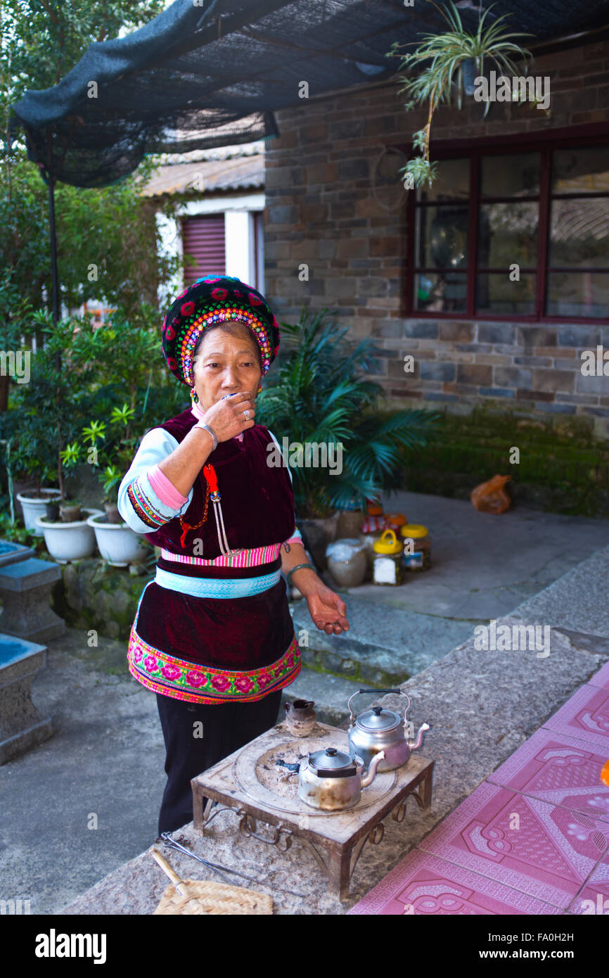 Ethnic Bai lady preparing a special tea,in local everyday costume near ...