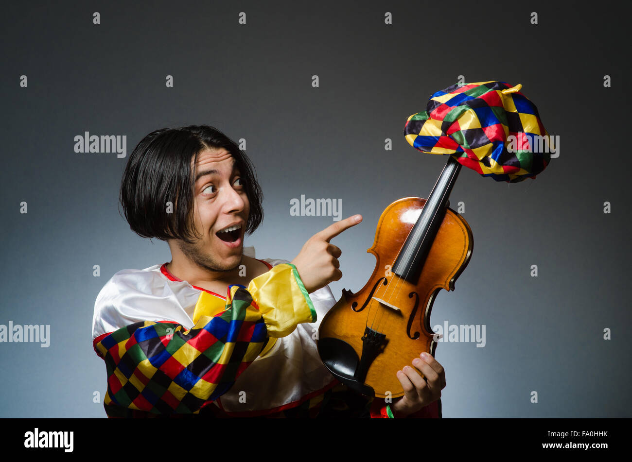 Funny violin clown player in musical concept Stock Photo - Alamy