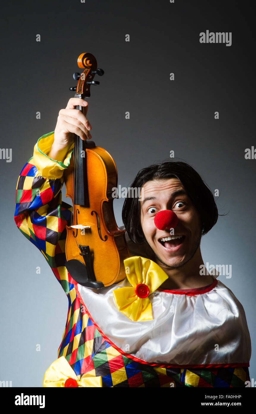 Funny violin clown player in musical concept Stock Photo - Alamy