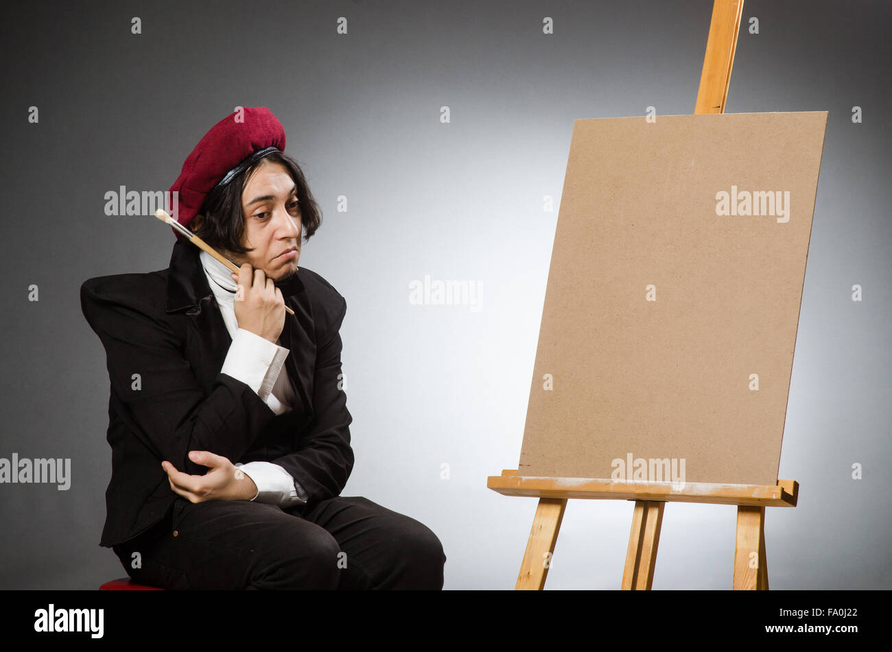 Funny artist in dark studio Stock Photo - Alamy