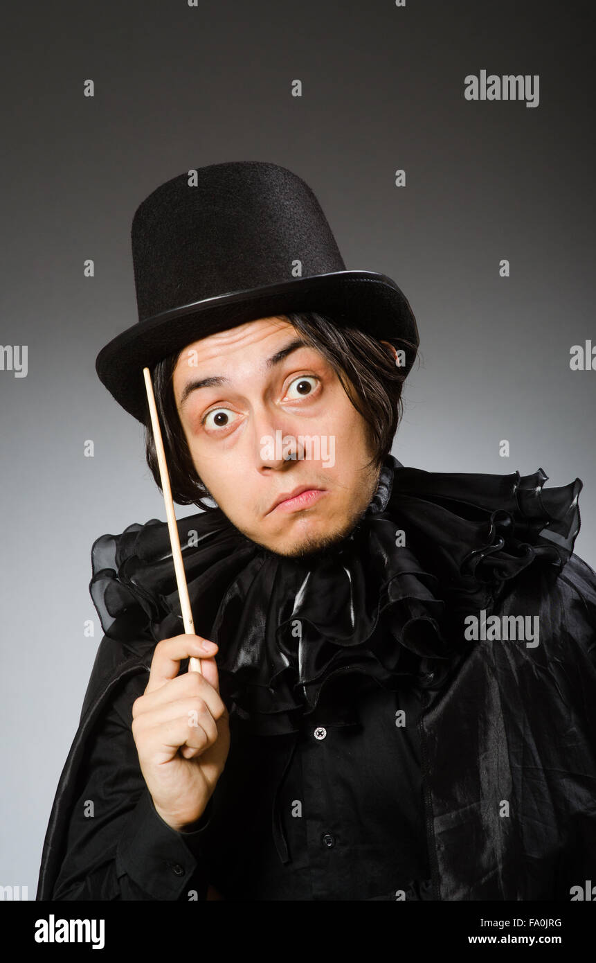 Funny magician wearing cylinder hat Stock Photo - Alamy