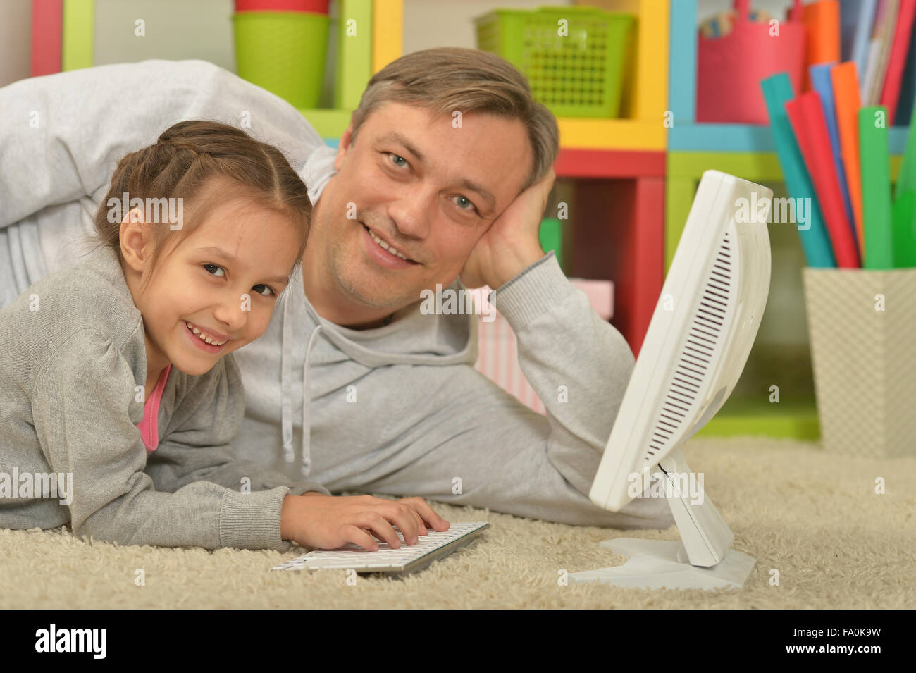 father and little daughter with computer Stock Photo - Alamy