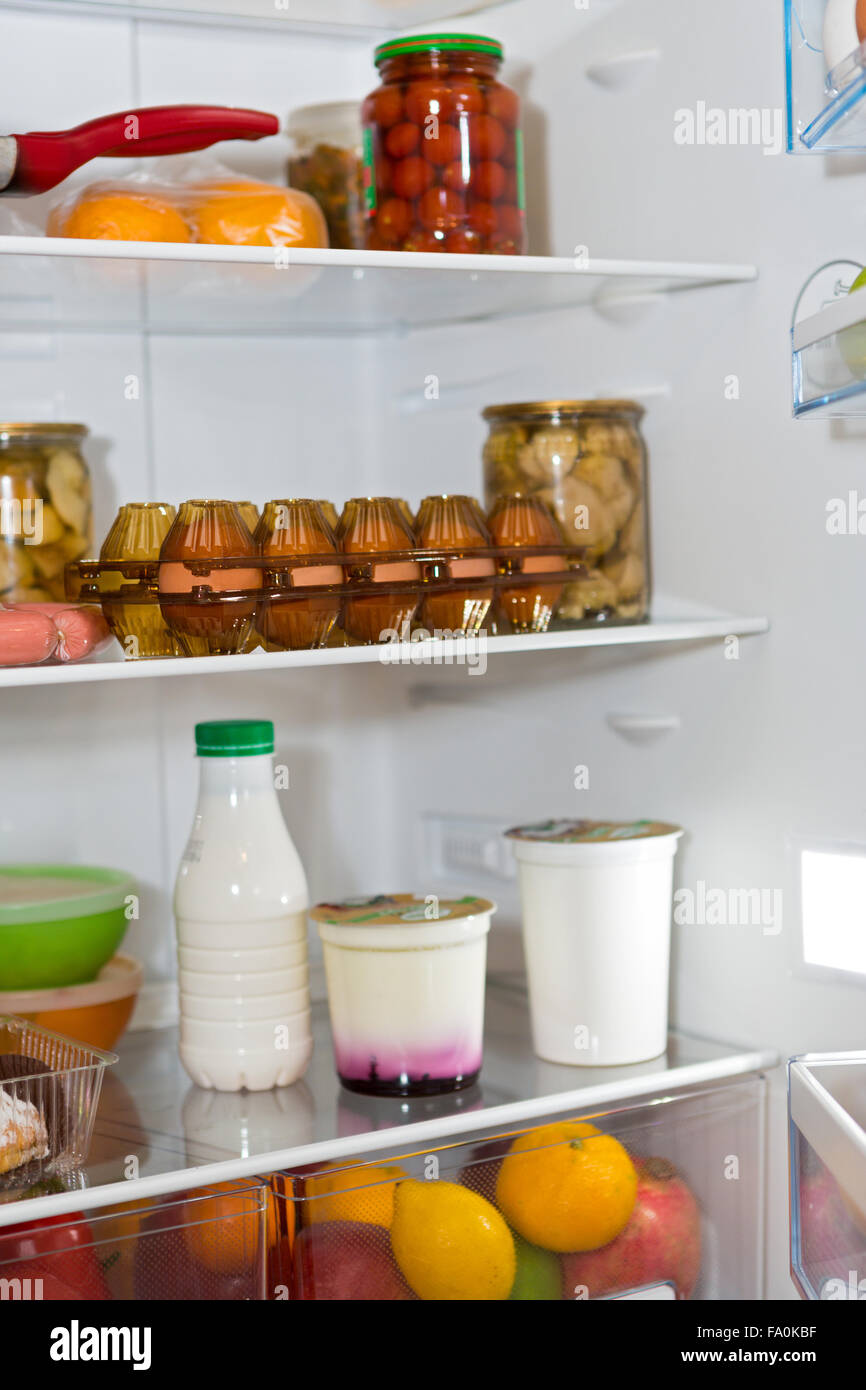 Domestic refrigerator full of a variety of foods, vegetables and fruits ...