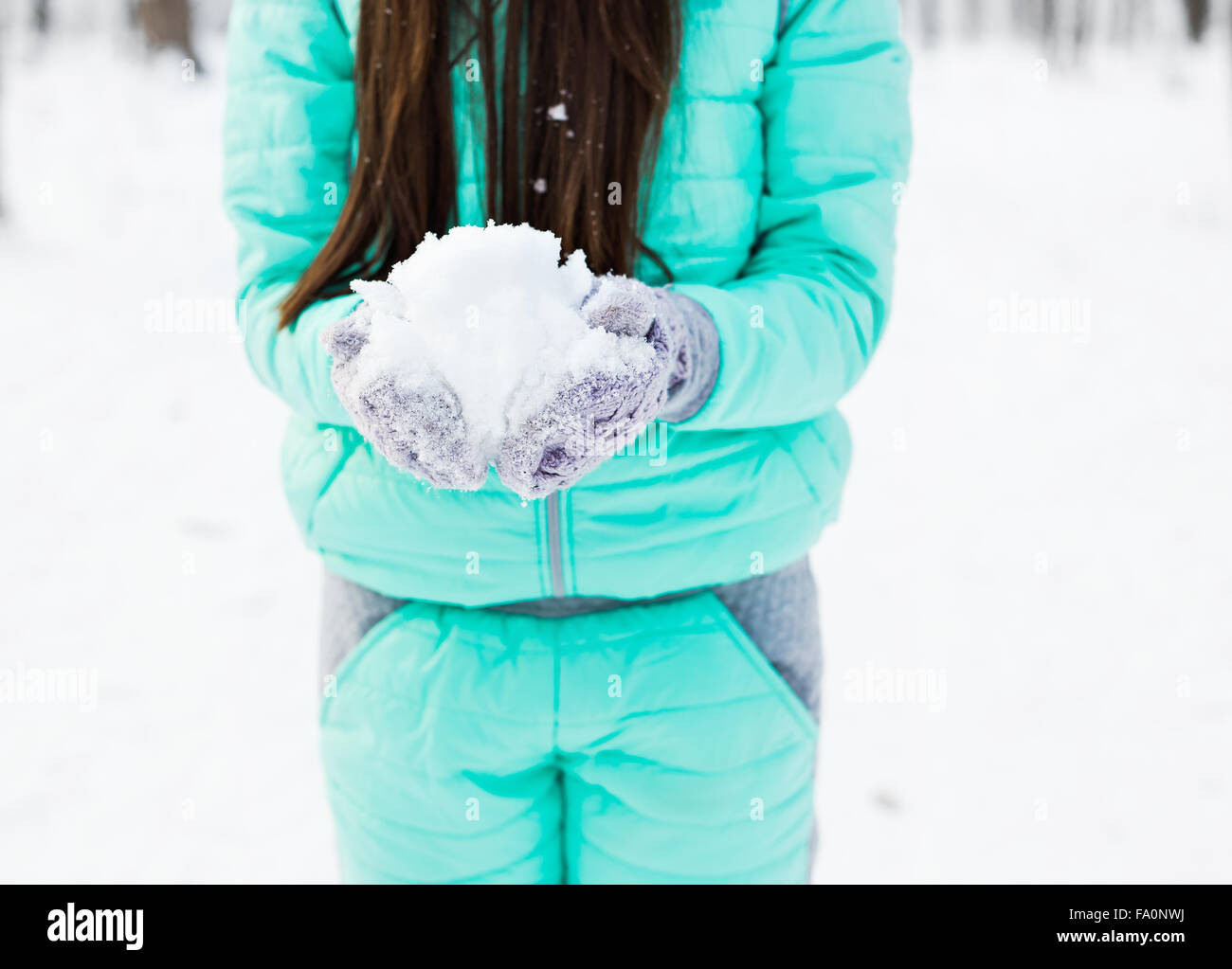 girl holding snow in hands Stock Photo - Alamy