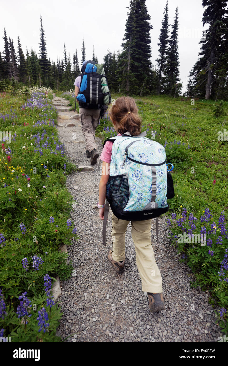 Female child and mother backpacking on trail, Spray Park, Mount Rainier ...