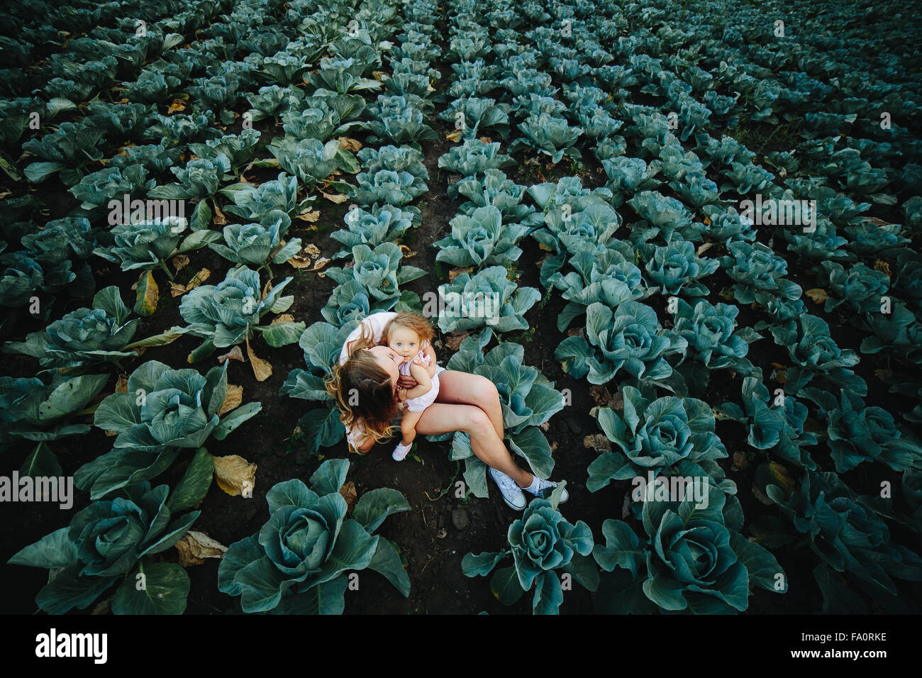 Mother and daughter on the field with cabbage Stock Photo - Alamy