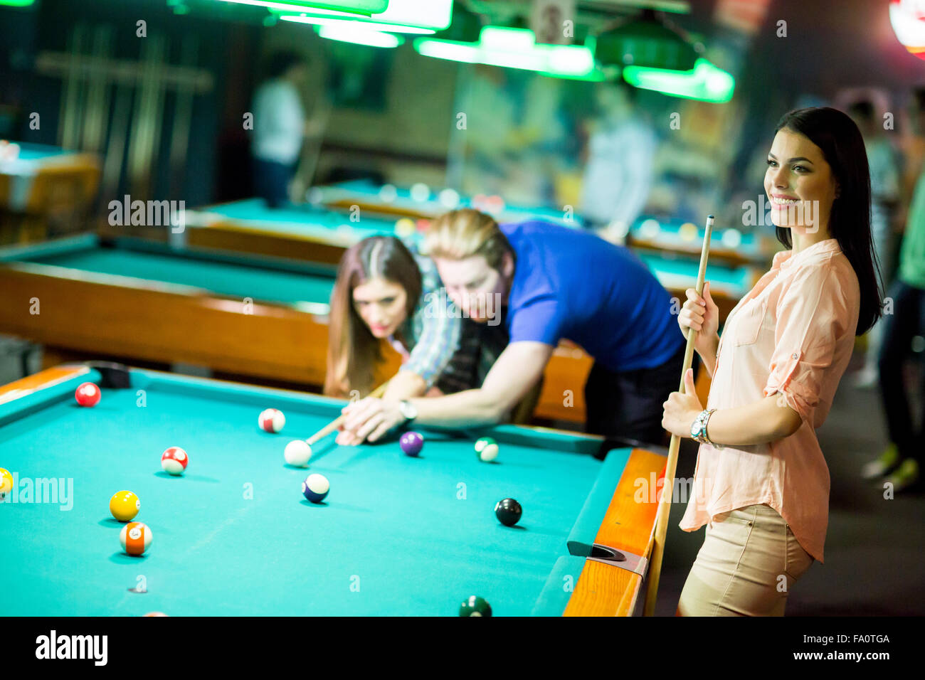 Young people playing pool Stock Photo - Alamy