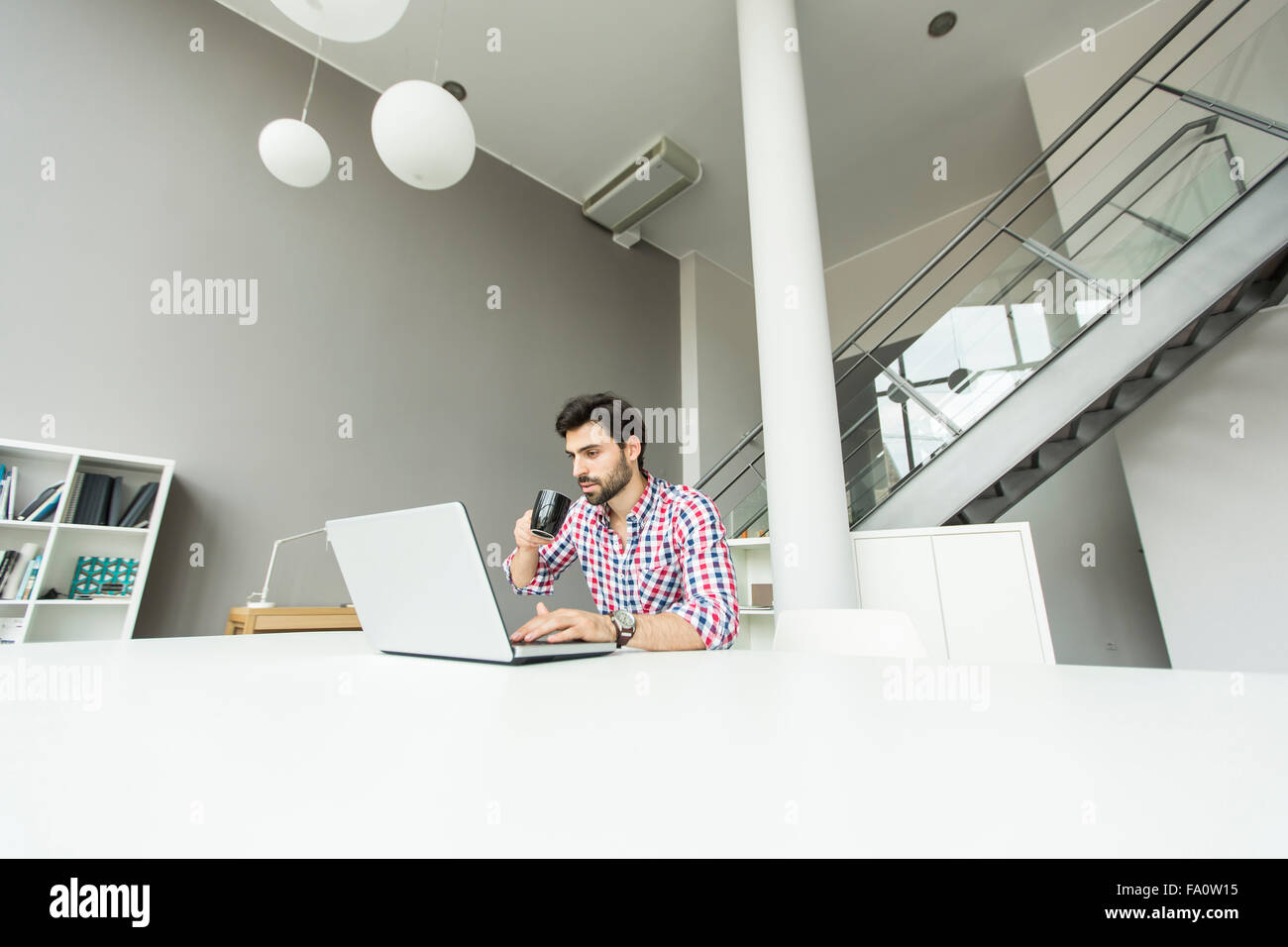 Young man at the office Stock Photo - Alamy