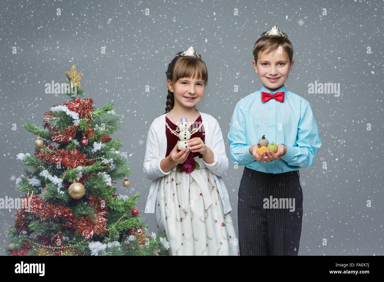 Children near christmas tree Stock Photo - Alamy