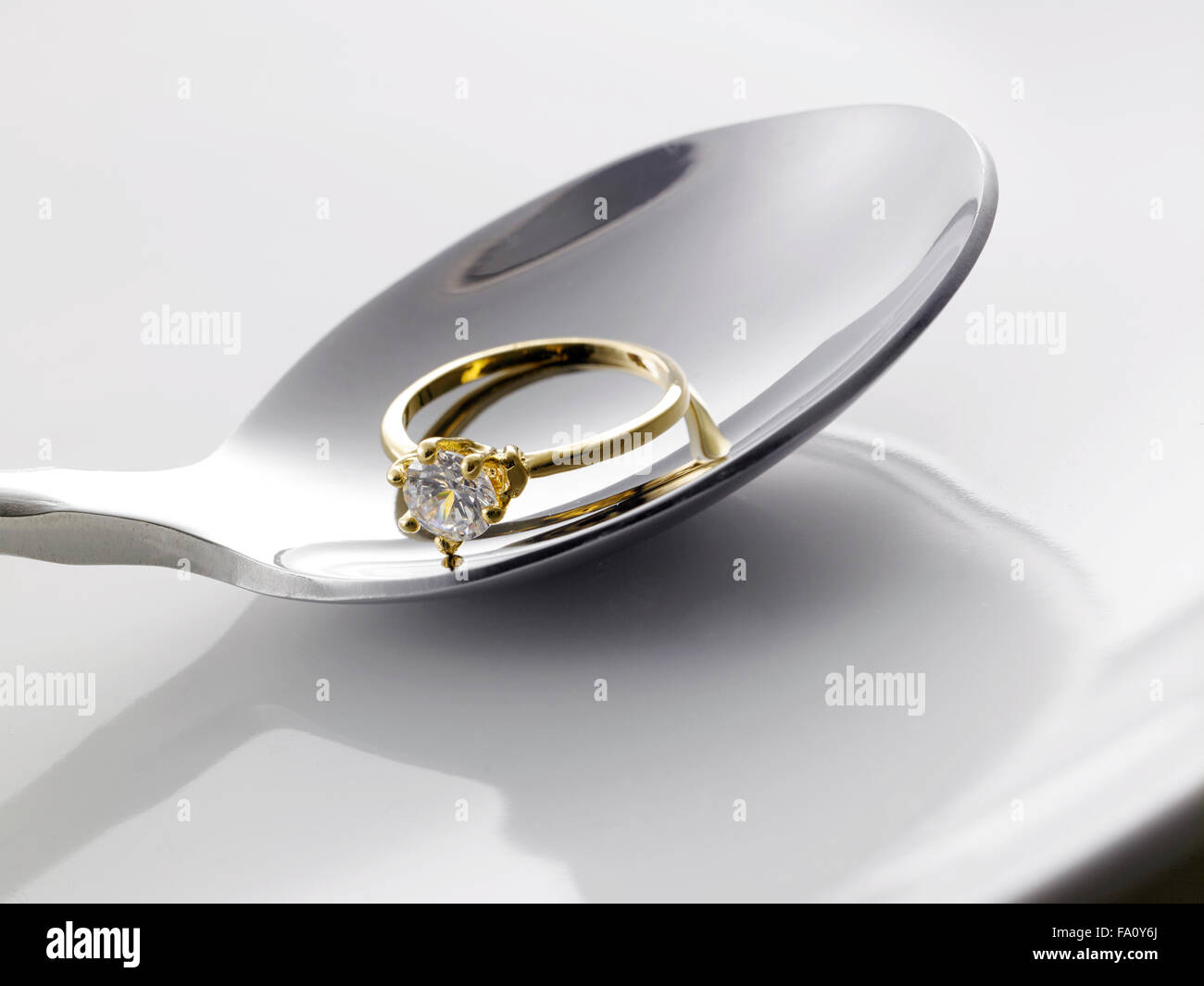 Diamond Ring in silver spoon isolated on white background Stock Photo ...