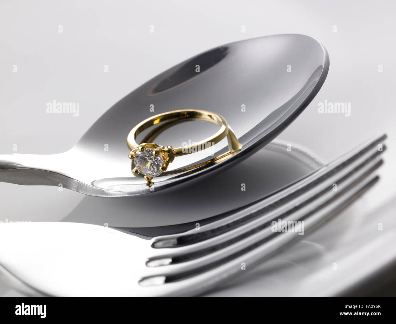 Diamond Ring in silver spoon isolated on white background Stock Photo ...