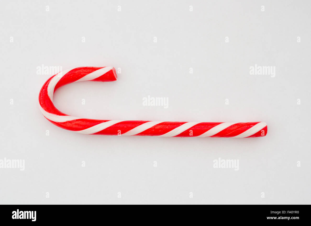 A red and white striped, Christmas candy cane on a white background ...
