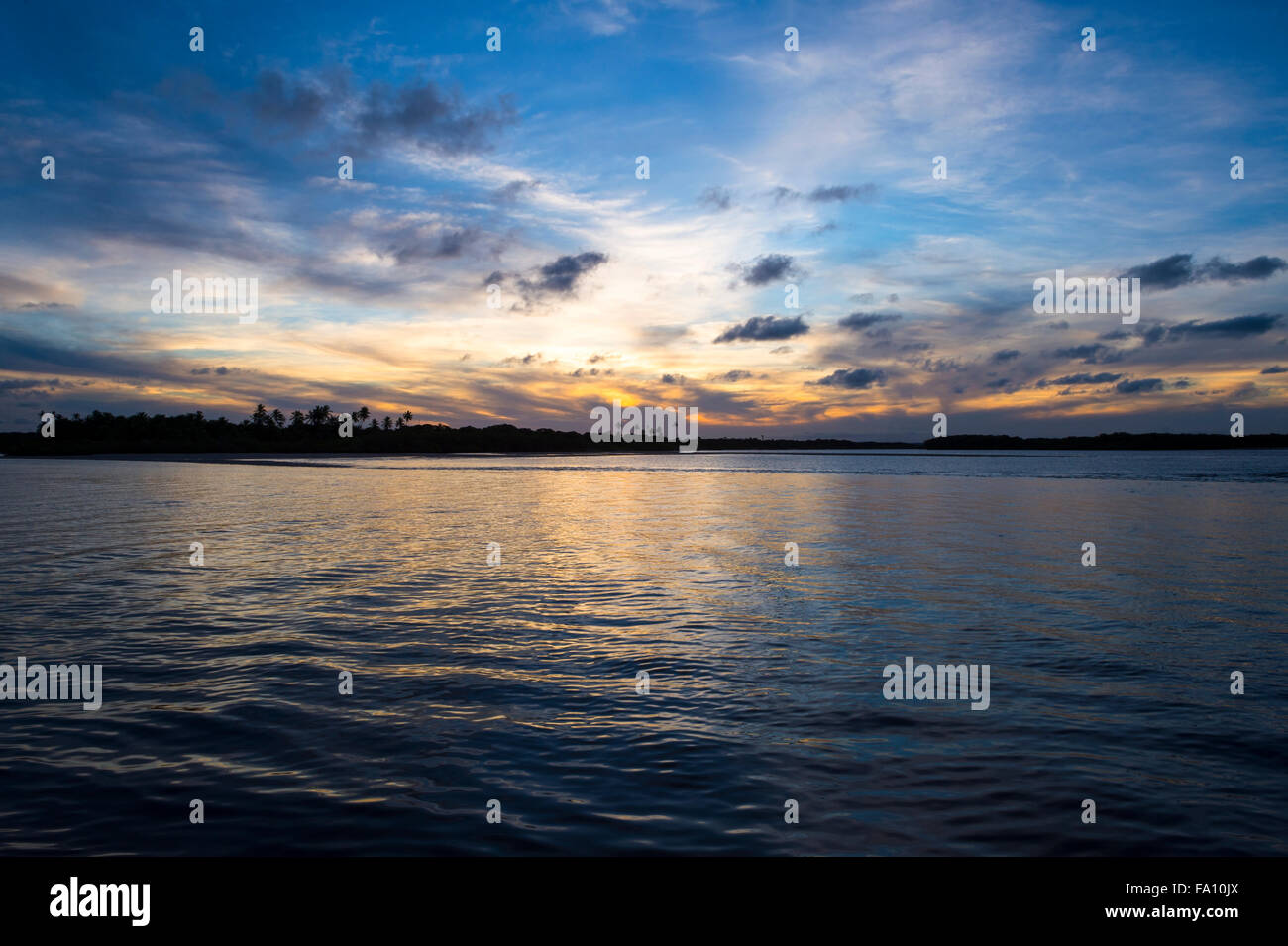 Scenic sunset island landscape view with tranquil waters and colorful ...