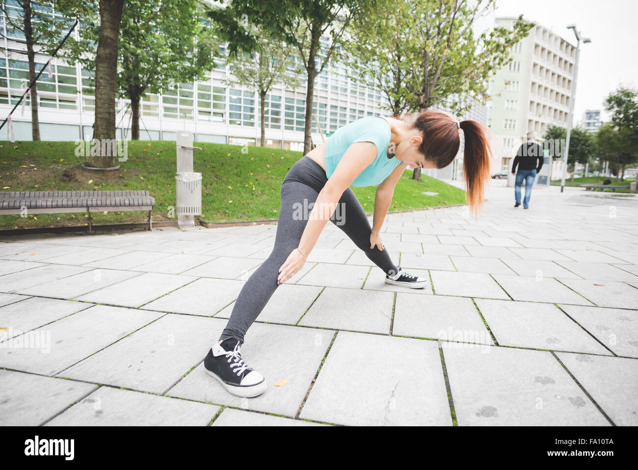 young handsome caucasian reddish straight hair woman doing stretching ...