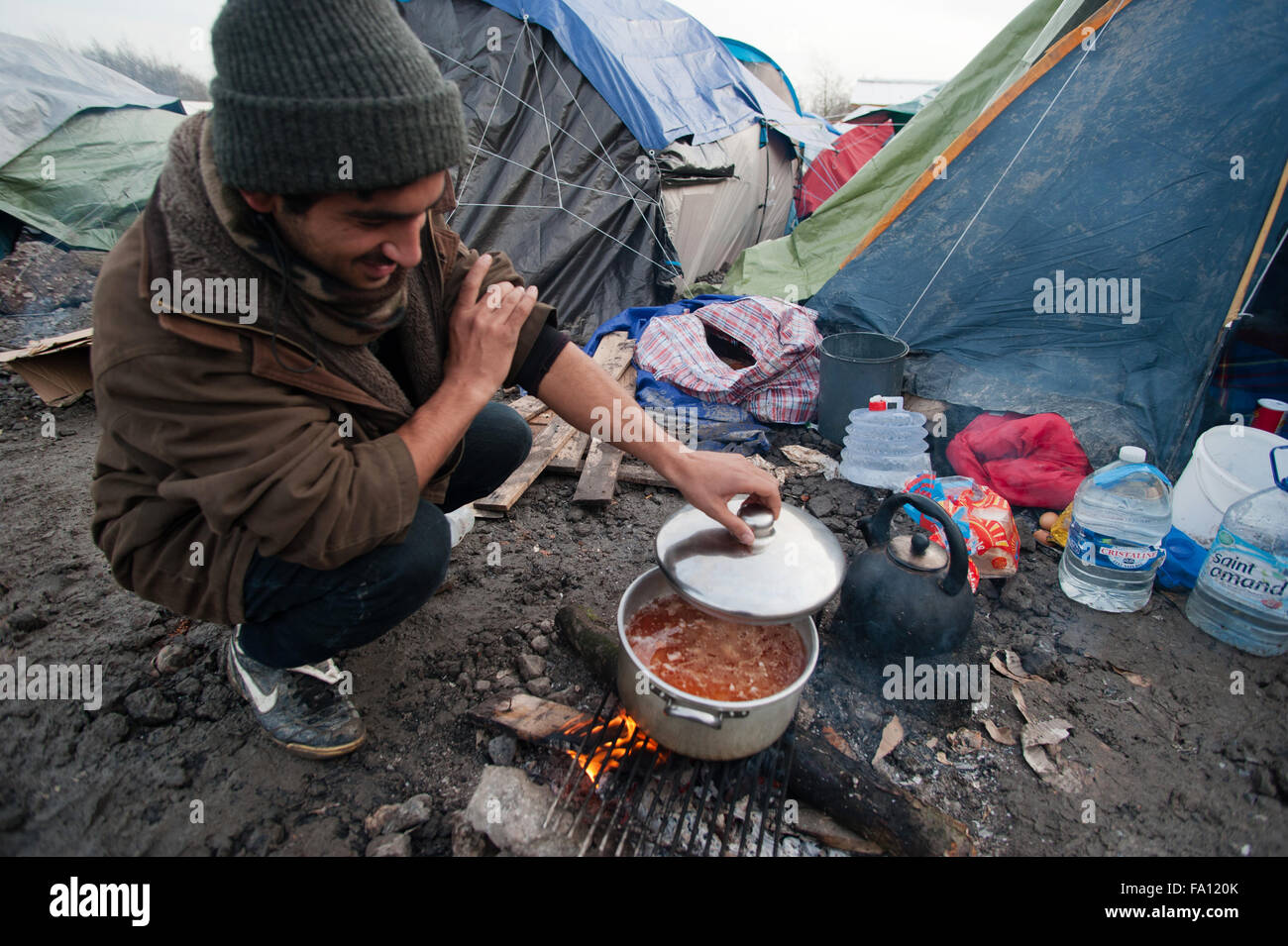 Dunkirk, France. 17th Dec, 2015. A young refugee is seen cooking a meal ...