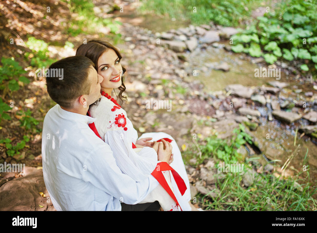 Love story of loving couple in national Ukraine dress. On the wood with ...