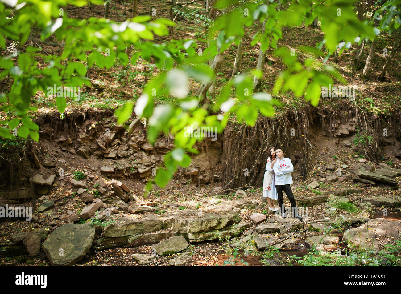 Love story of loving couple in national Ukraine dress. On the wood with ...