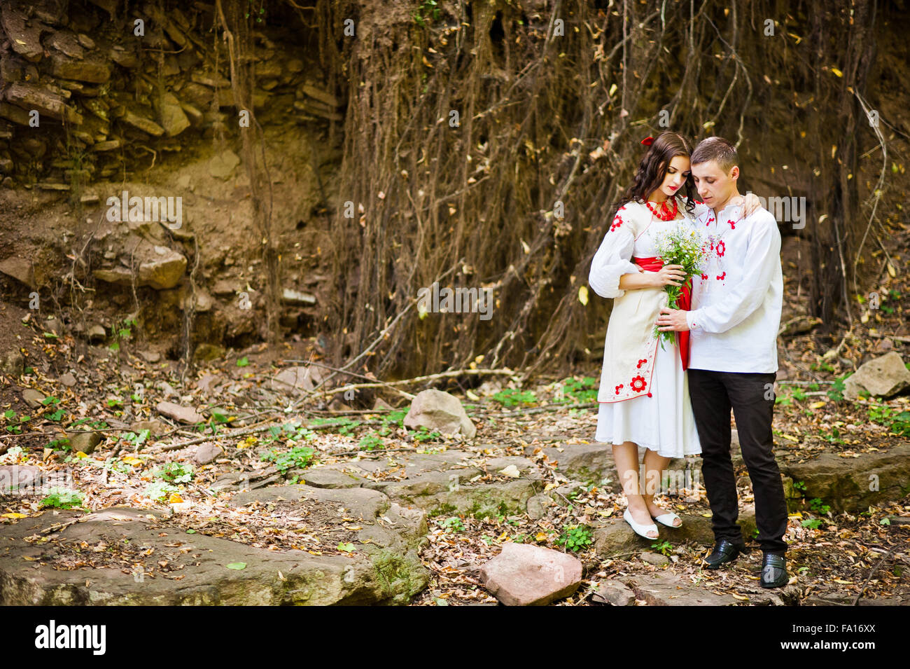Love story of loving couple in national Ukraine dress. On the wood with ...