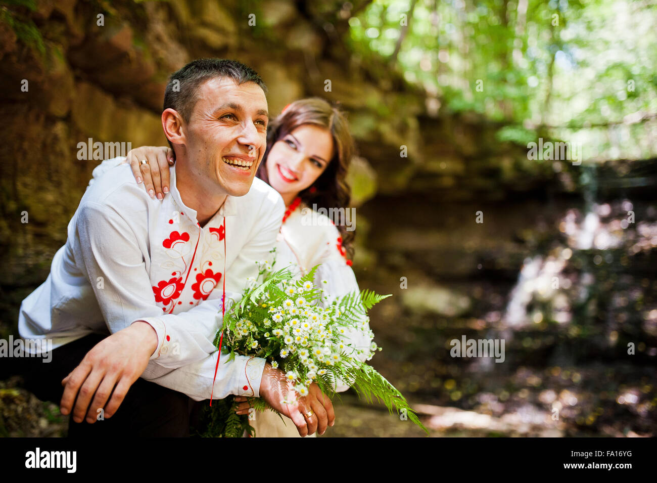 Love story of loving couple in national Ukraine dress. On the wood with ...
