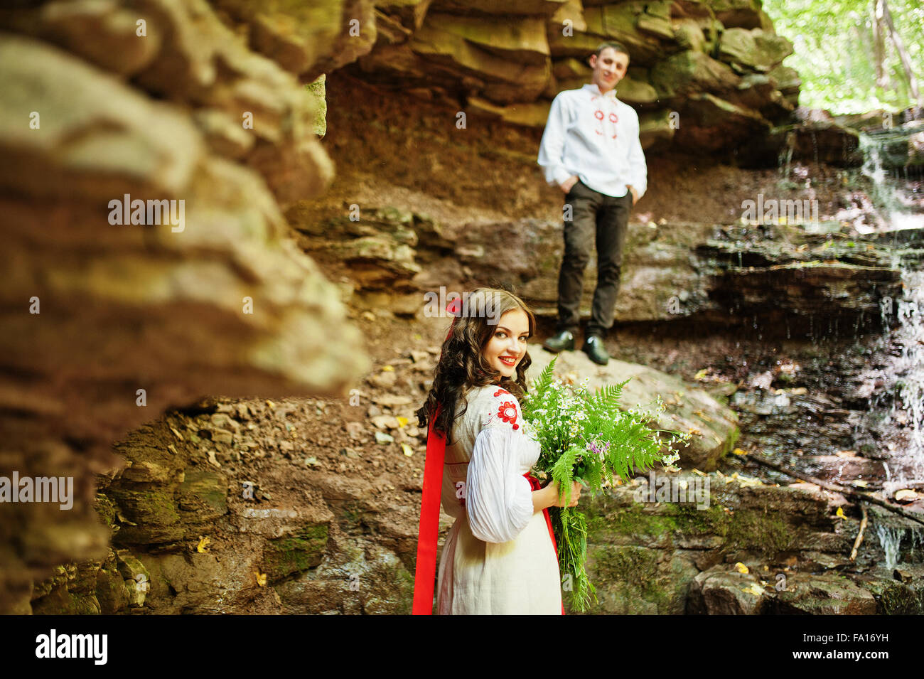 Love story of loving couple in national Ukraine dress. On the wood with ...