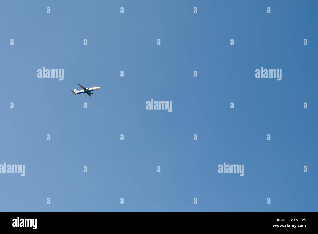 Airplane On Clear Blue Summer Sky Stock Photo - Alamy