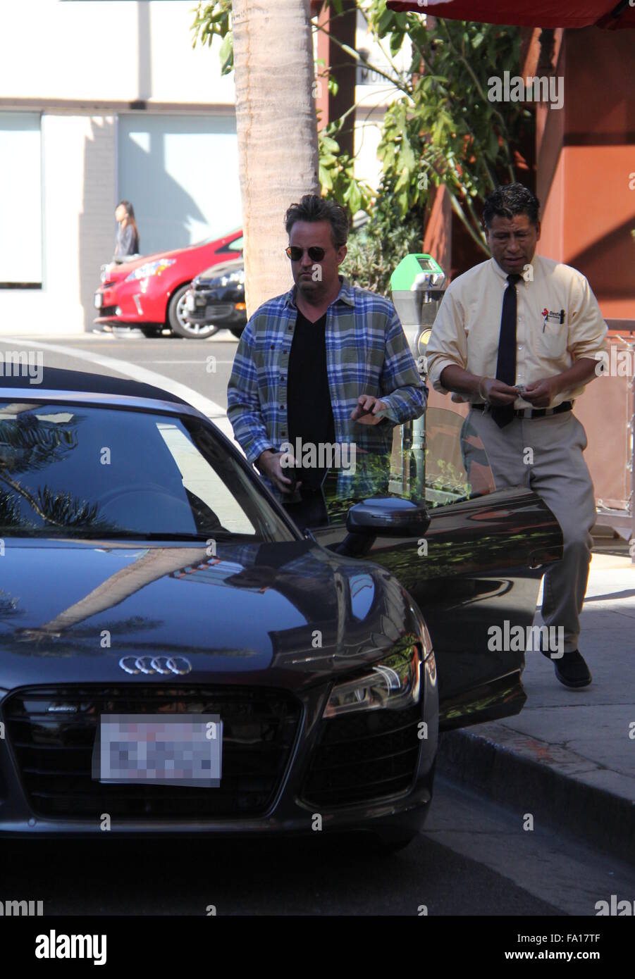 Matthew Perry seen using his phone whilst he wait for his Audi car ...