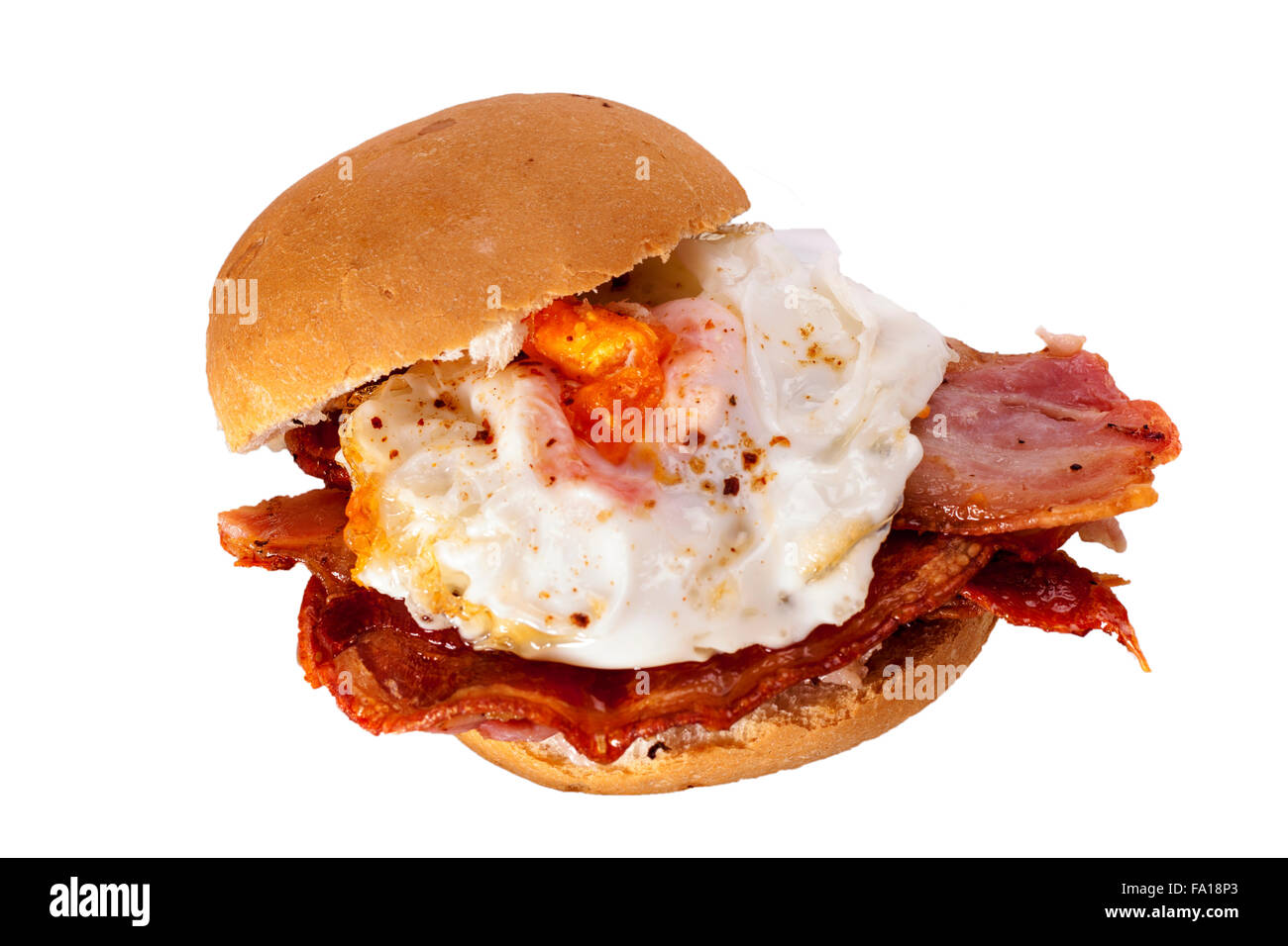 A delicious bacon and egg bun on a white background. Bacon and egg bun ...