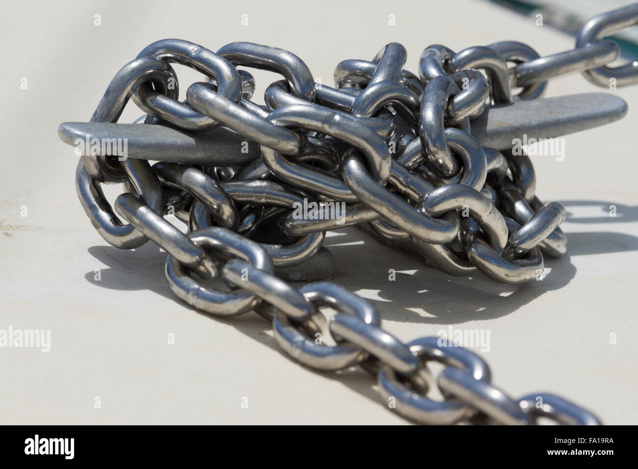 An anchor chain wrapped around a mooring cleat on a catamaran in the ...