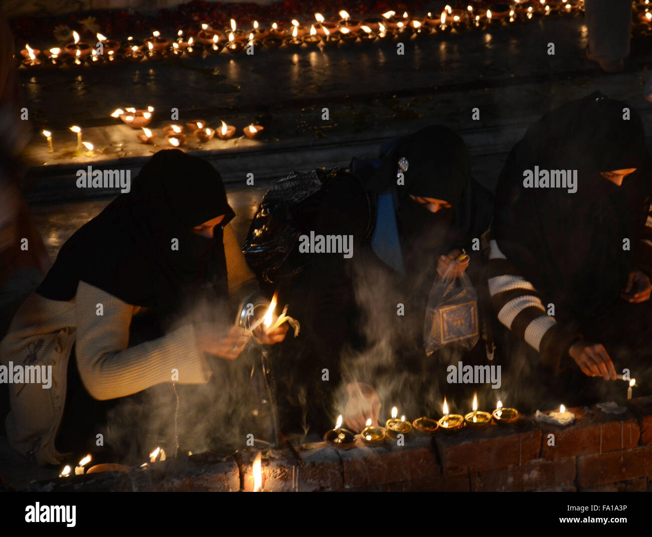 Lahore, Pakistan. 19th Dec, 2015. Pakistani Muslim devotees light ...