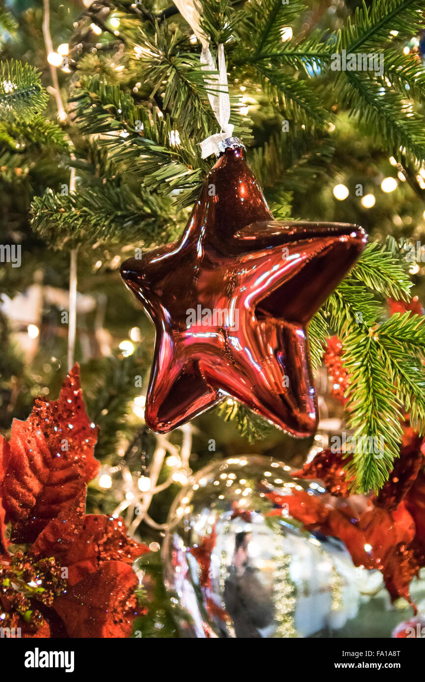 Detail of a christmas tree decorated with a red star Stock Photo - Alamy