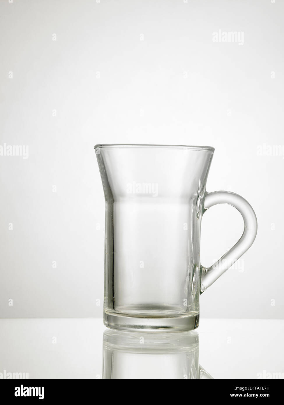 Glass transparent empty mug, with reflection on a white background ...