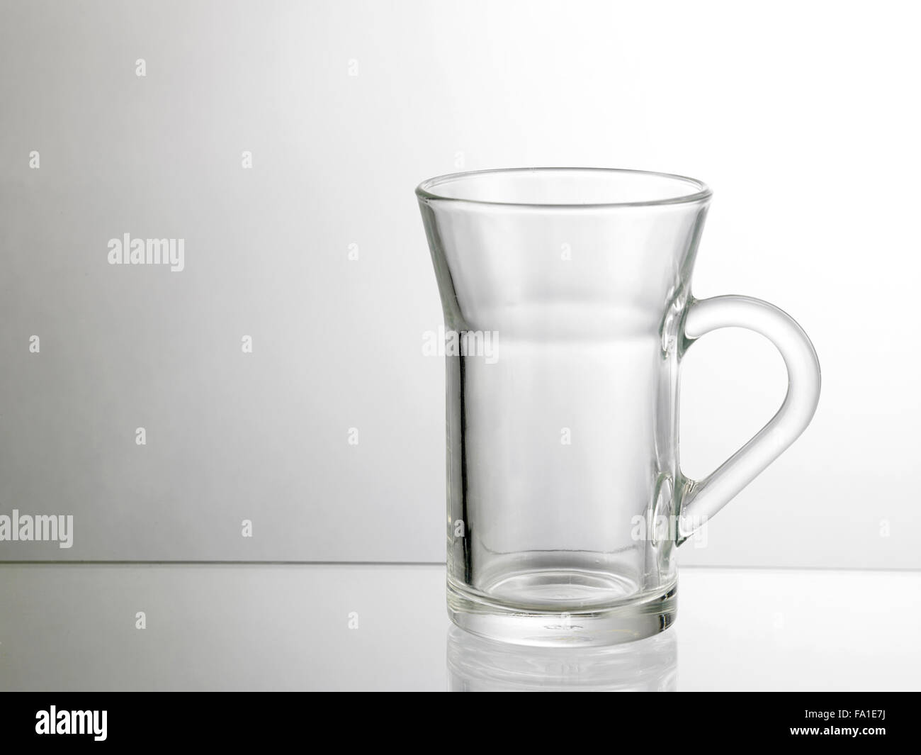 Glass transparent empty mug, with reflection on a white background ...
