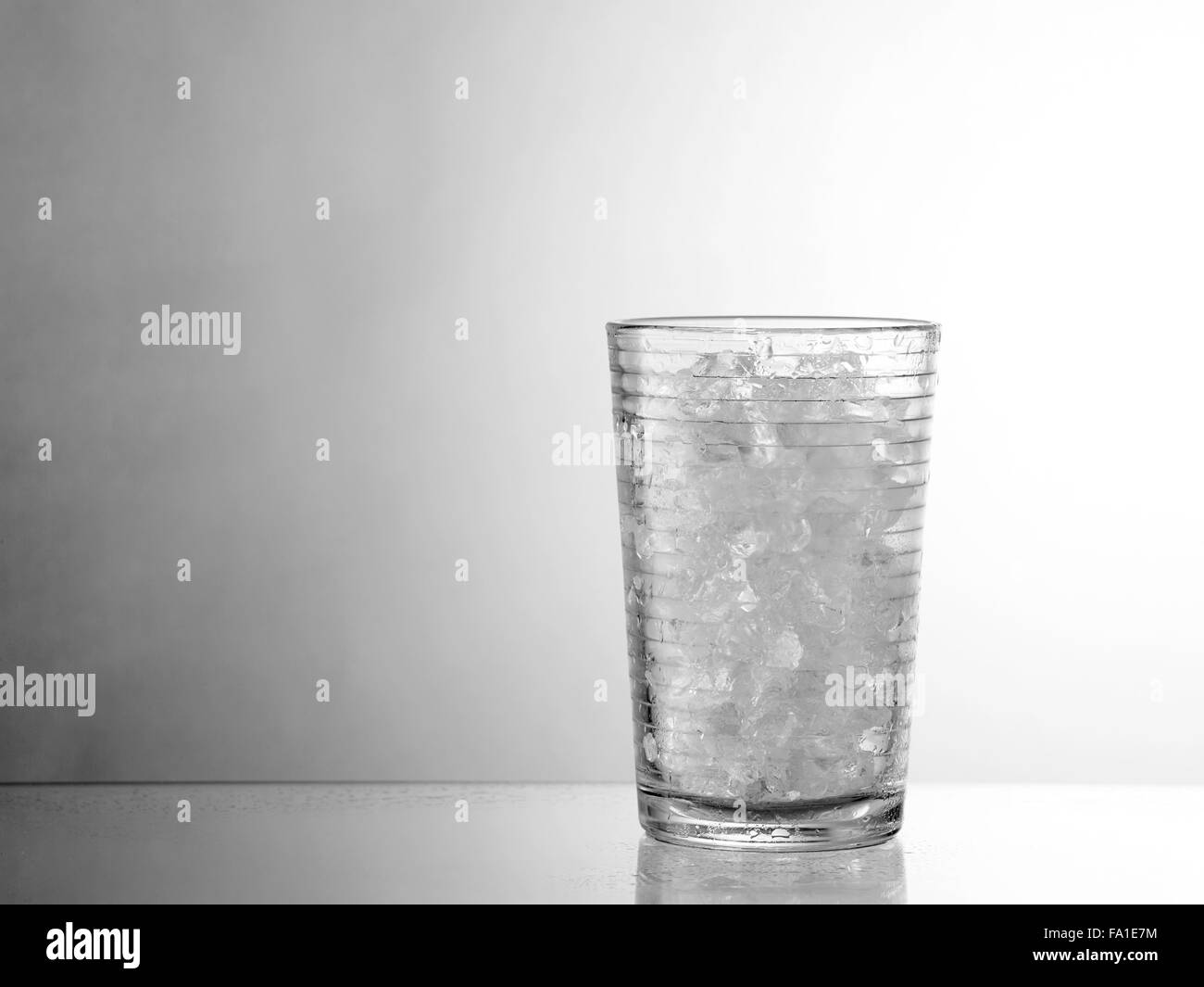 empty glass with ice cubes on white background Stock Photo - Alamy