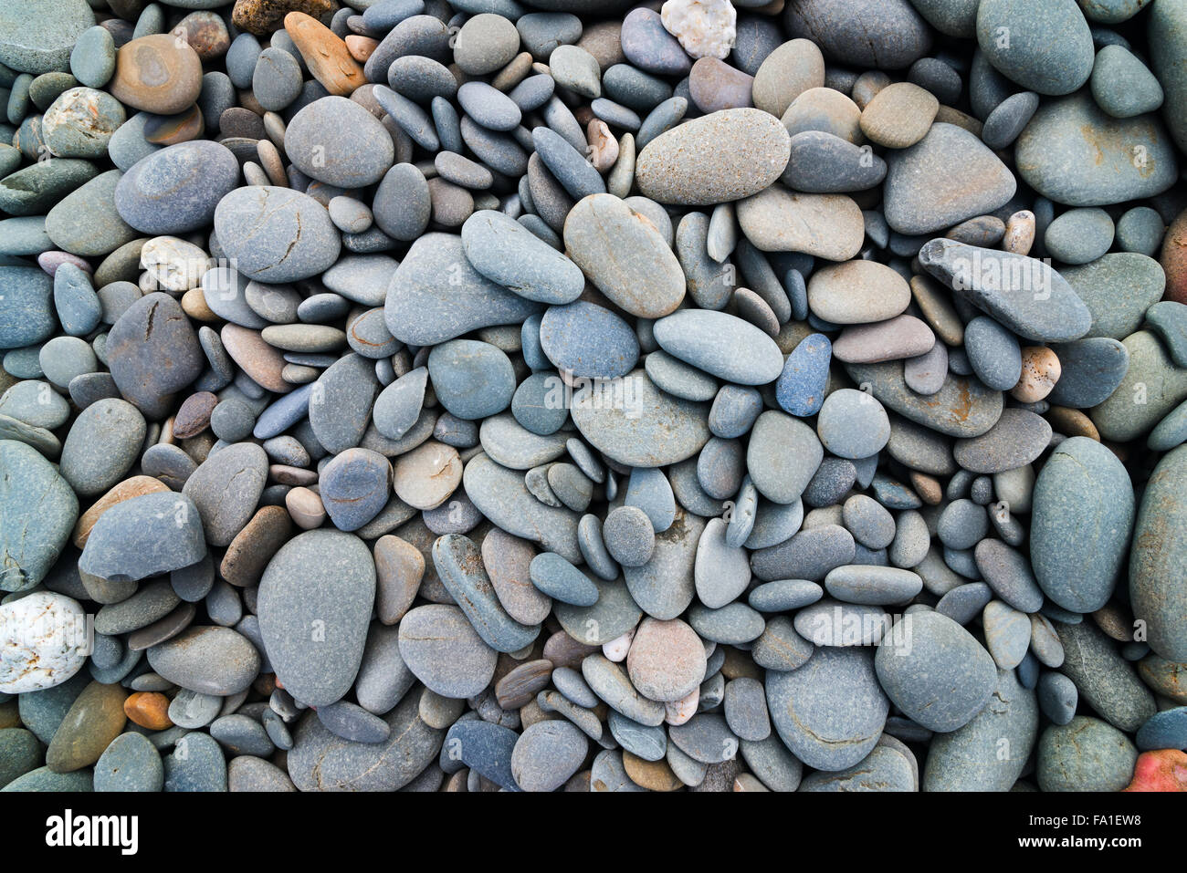 Pebbles stones smooth background mix color and shape Stock Photo - Alamy
