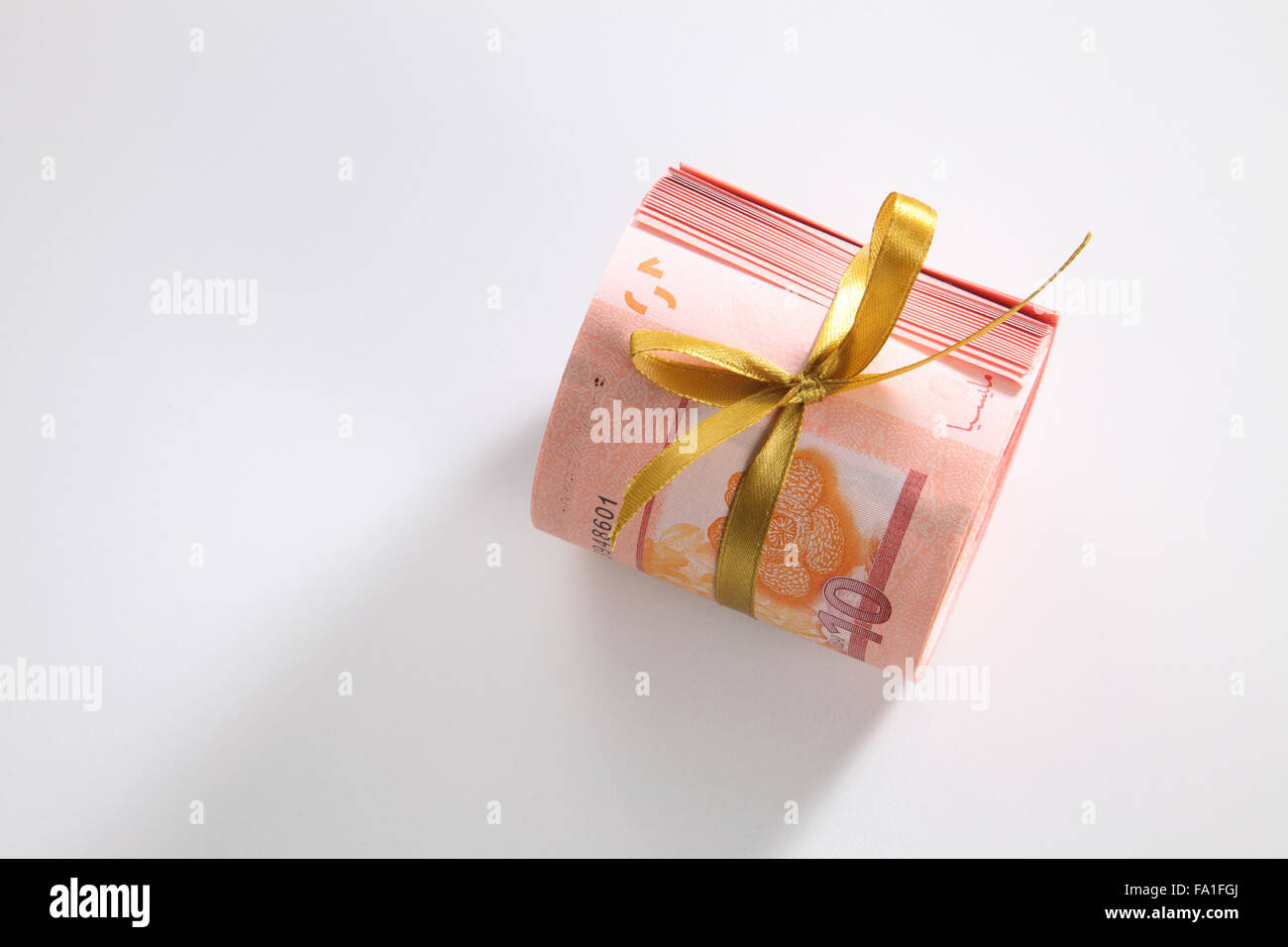 Malaysia ringgit roll tied with ribbon Stock Photo - Alamy