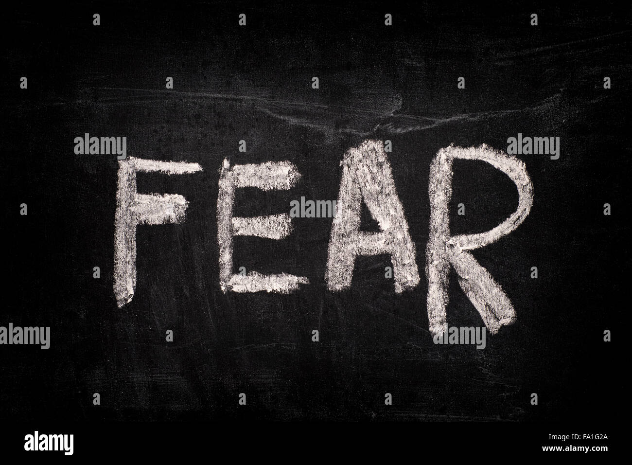Word Fear on a blackboard writing with chalk. Close up Stock Photo - Alamy