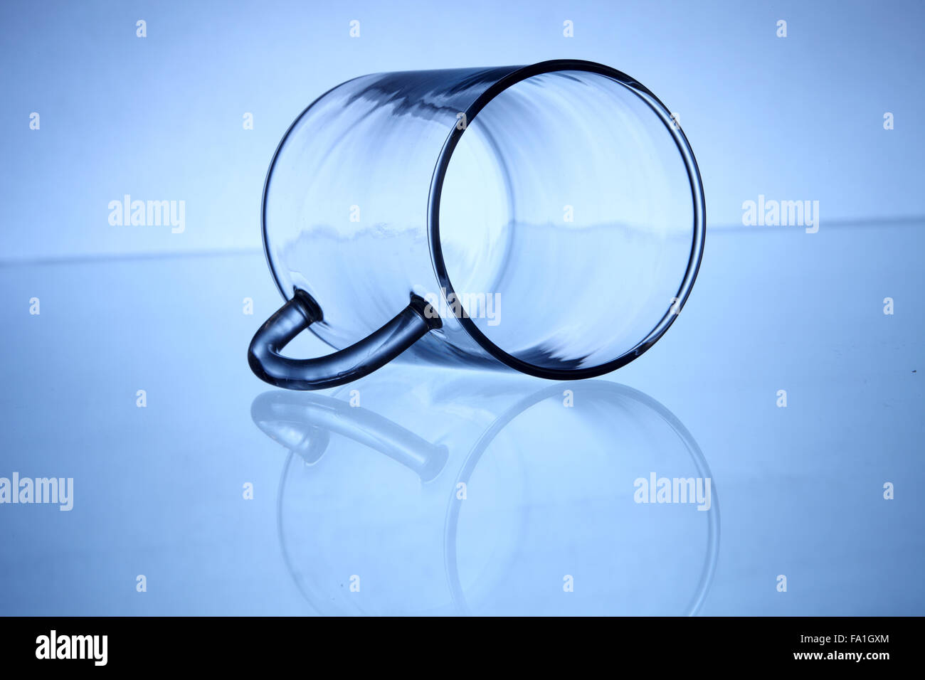glass cup laid down on top of glass table Stock Photo - Alamy