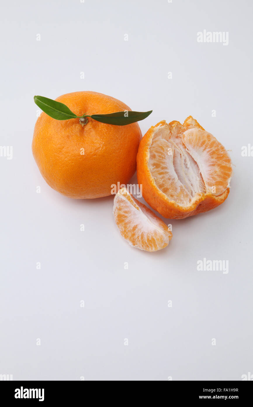 One mandarin orange and one half open Stock Photo - Alamy