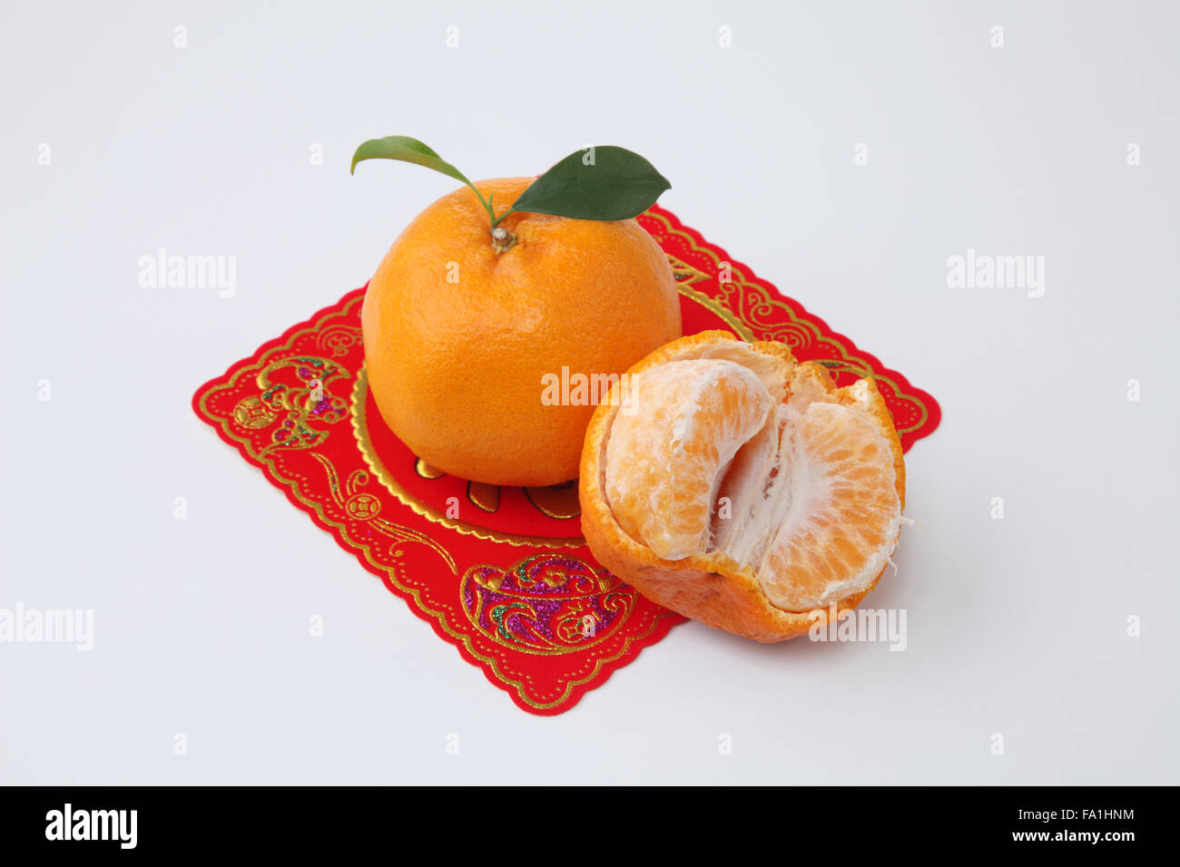 One mandarin orange and one half open Stock Photo - Alamy