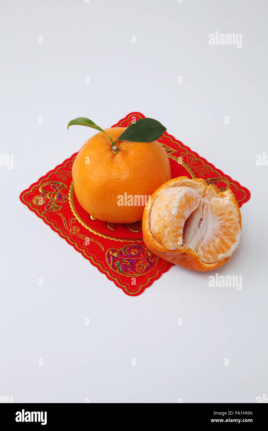 One mandarin orange and one half open Stock Photo - Alamy