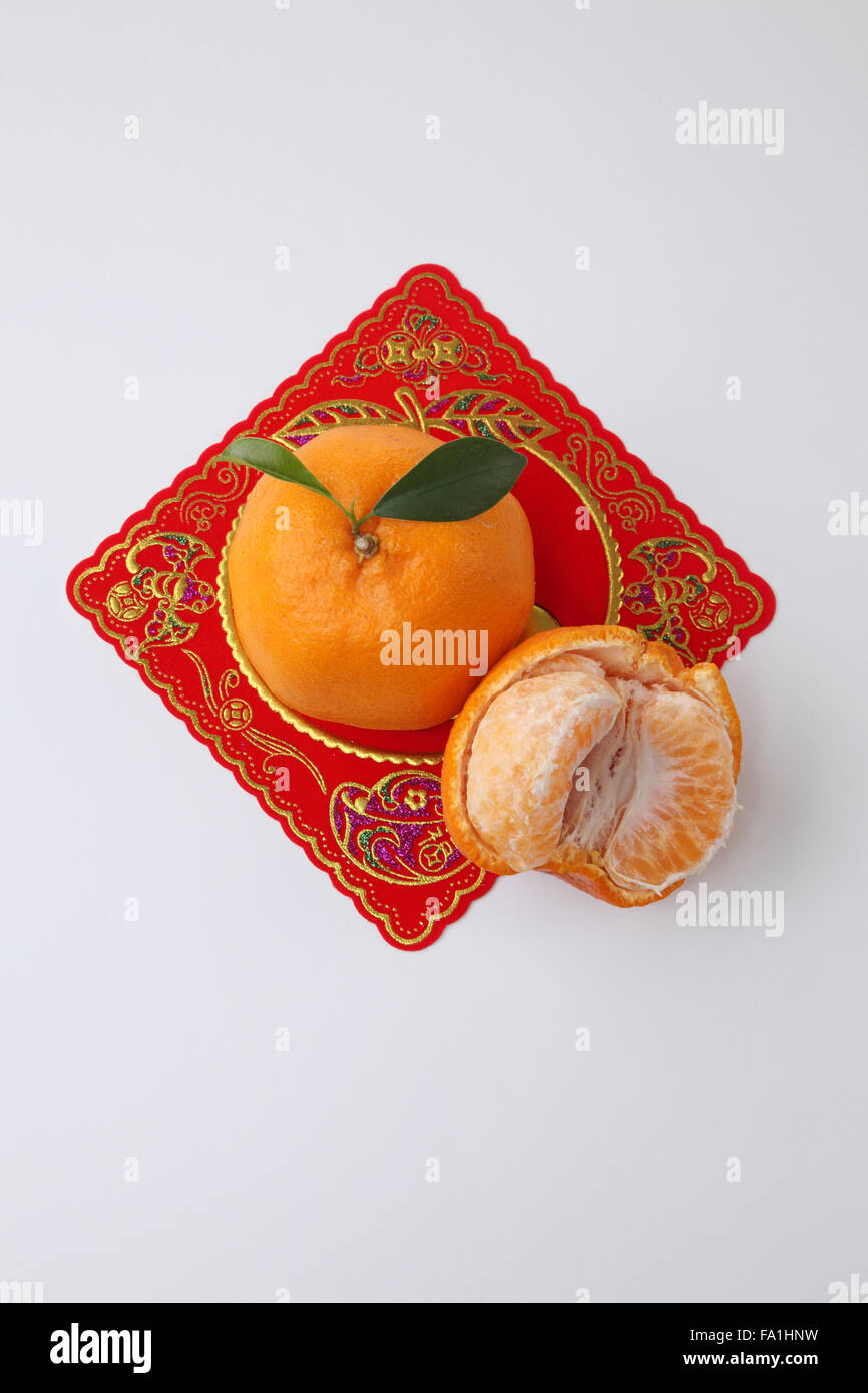 One mandarin orange and one half open Stock Photo - Alamy