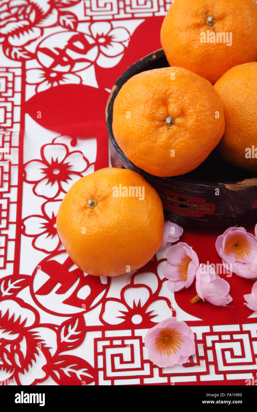 mandarin oranges on the red paper cutting Stock Photo - Alamy
