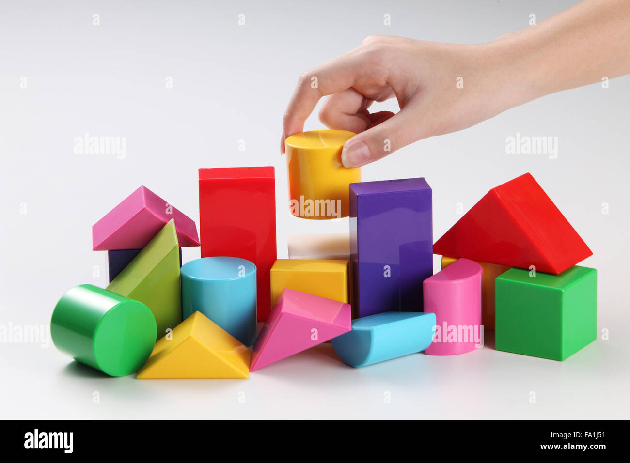 hand stacking colorful building block Stock Photo - Alamy