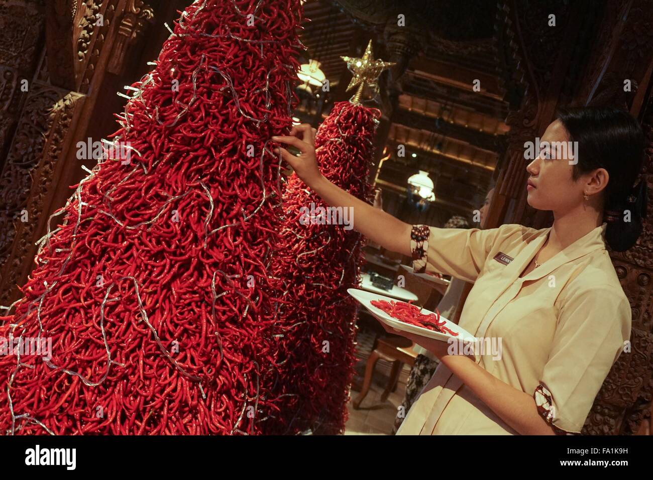 Pati, Indonesia. 19th Dec, 2015. A woman decorates a two-meter ...