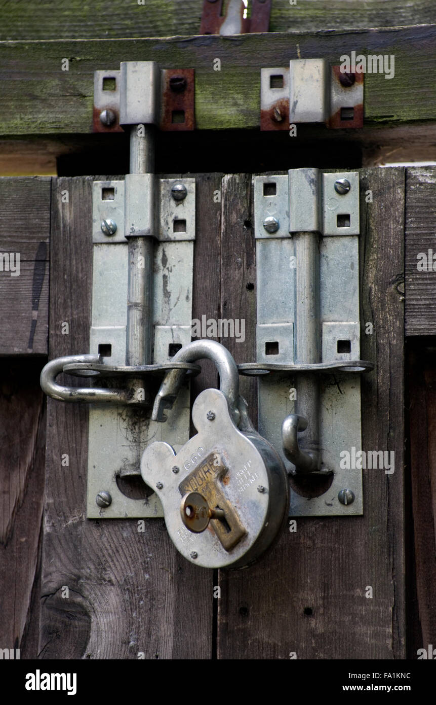 Padlock open on a wooden door Stock Photo - Alamy
