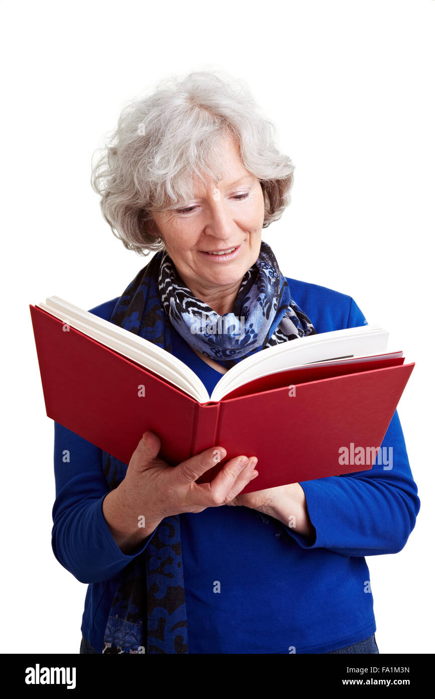Happy senior woman reading in a red book Stock Photo - Alamy
