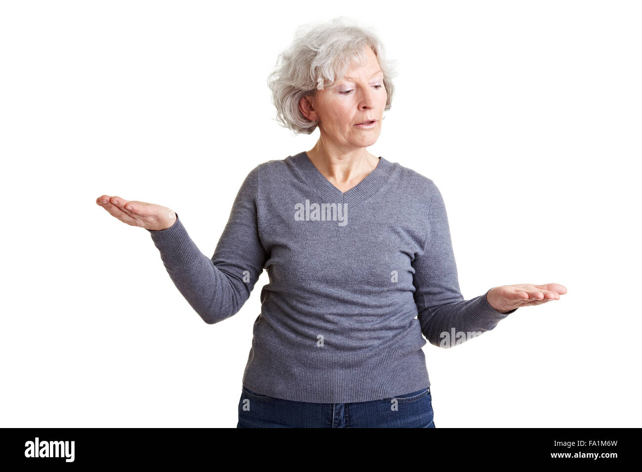 Elderly woman comparing two imaginary objects on her hands Stock Photo ...