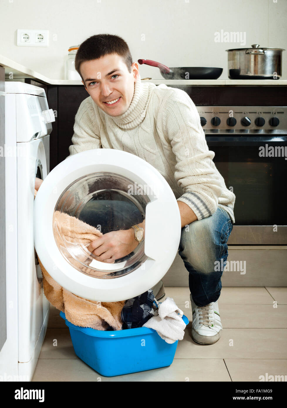 Home laundry smiling guy using hi-res stock photography and images - Alamy