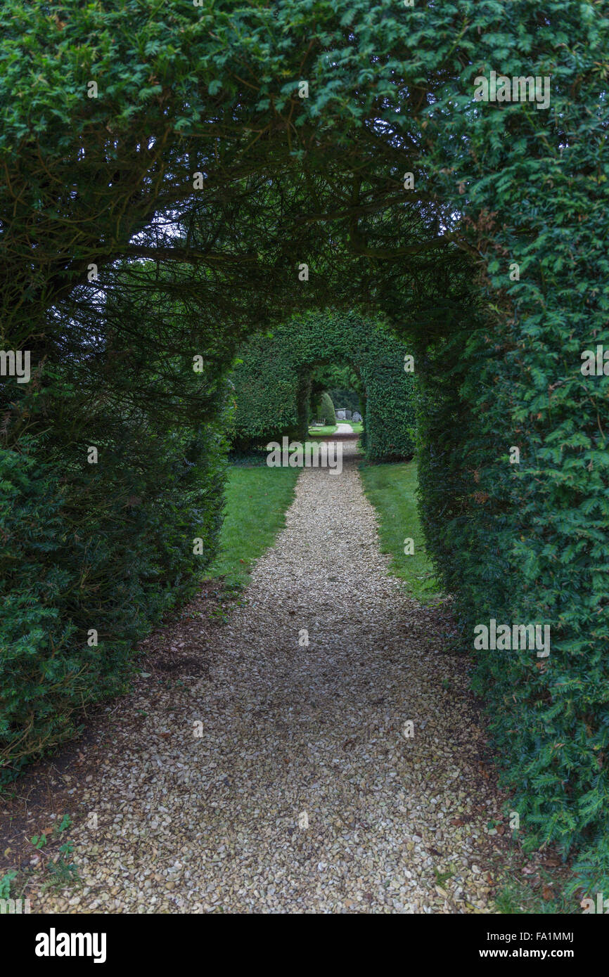 Pathway through the hedges towards Brimpsfield church Stock Photo - Alamy