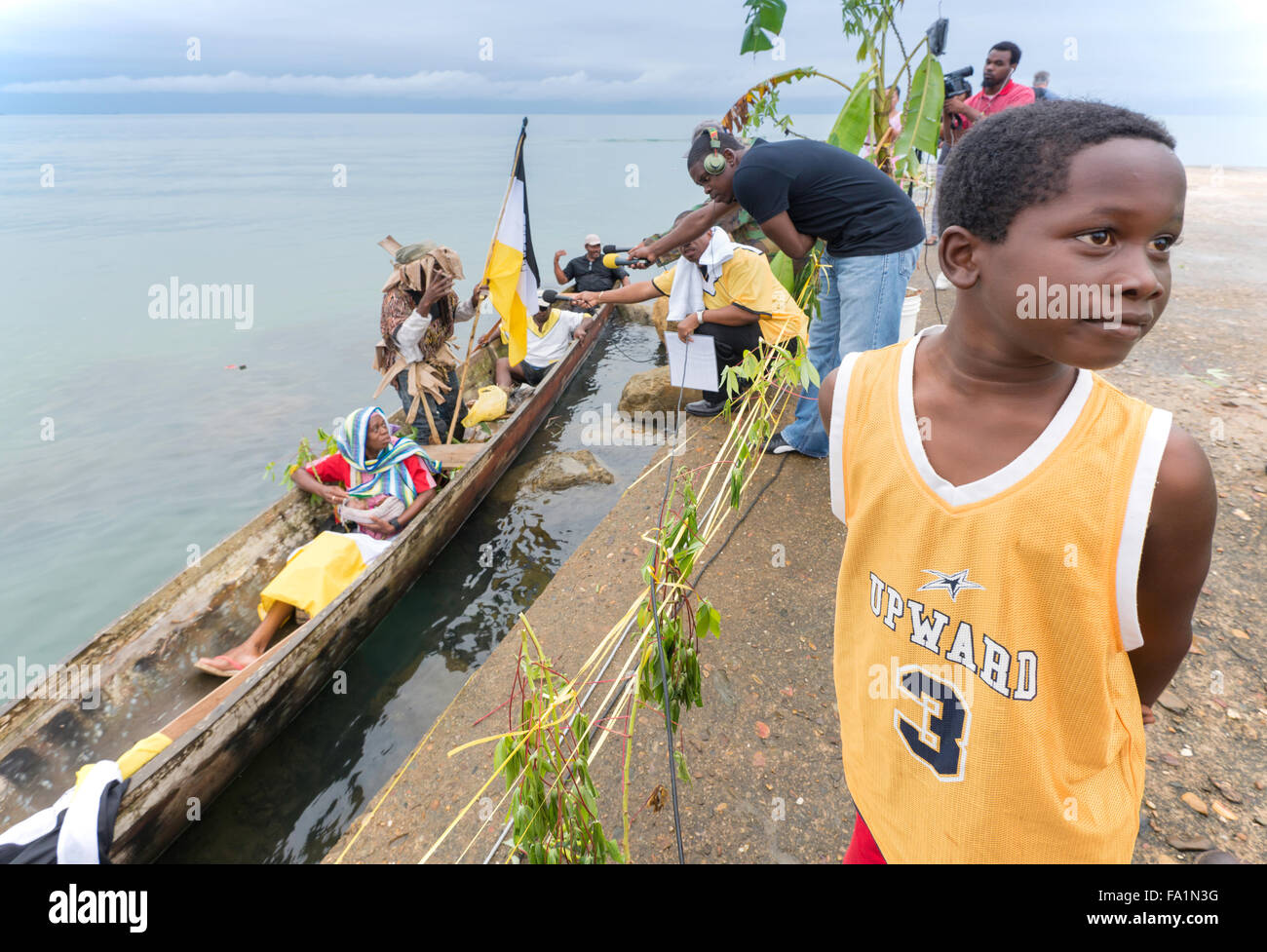 Garifuna people arriving in a canoe, young boy, TV crew, Garifuna ...